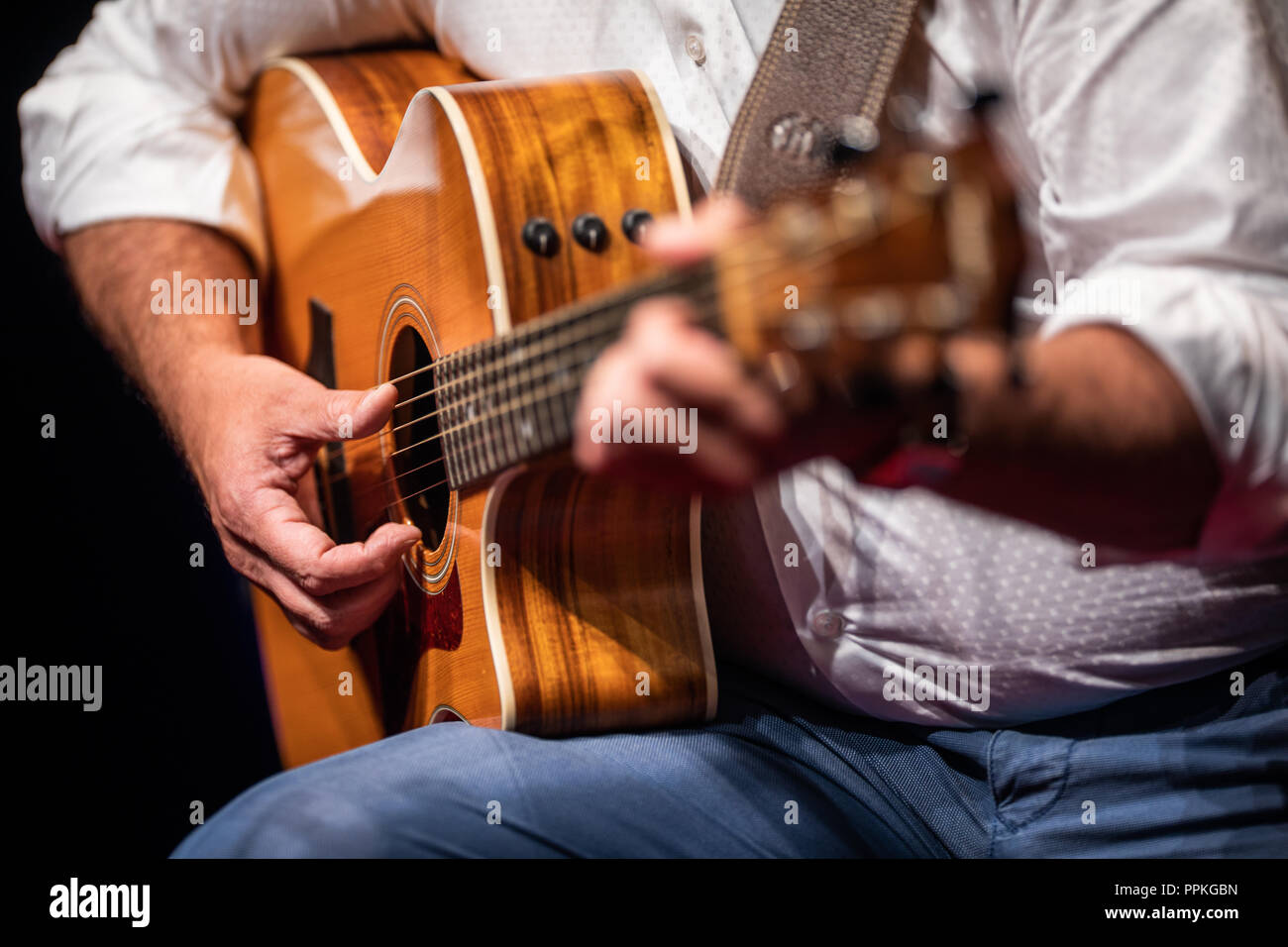 Man playing a guitar on stage (shallow DOF; color toned image Stock ...