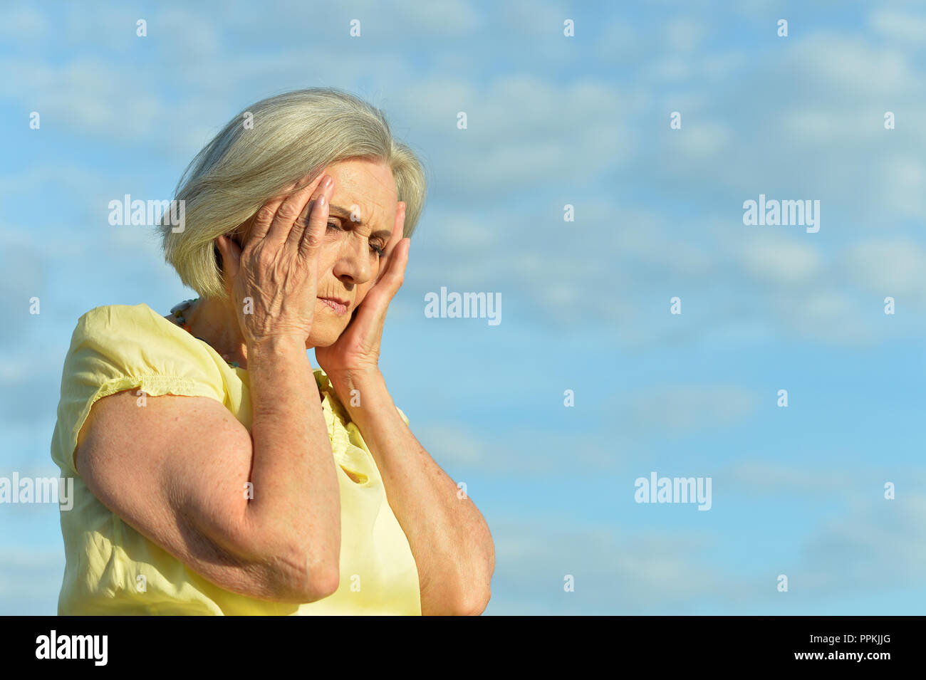 Portrait of smiling elderly woman posing outdoors Stock Photo - Alamy