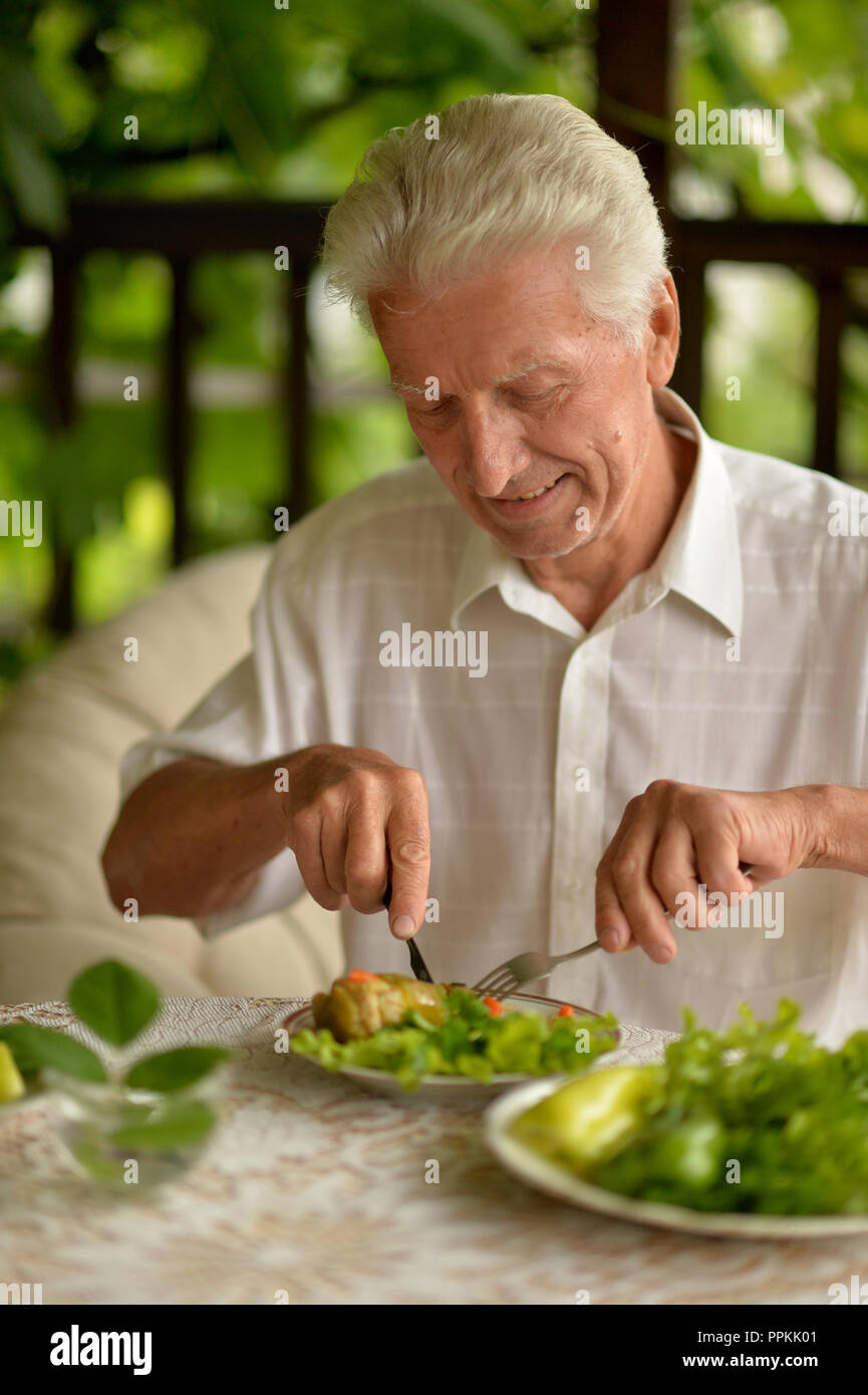 Handsome man eating fork knife hi-res stock photography and images - Alamy