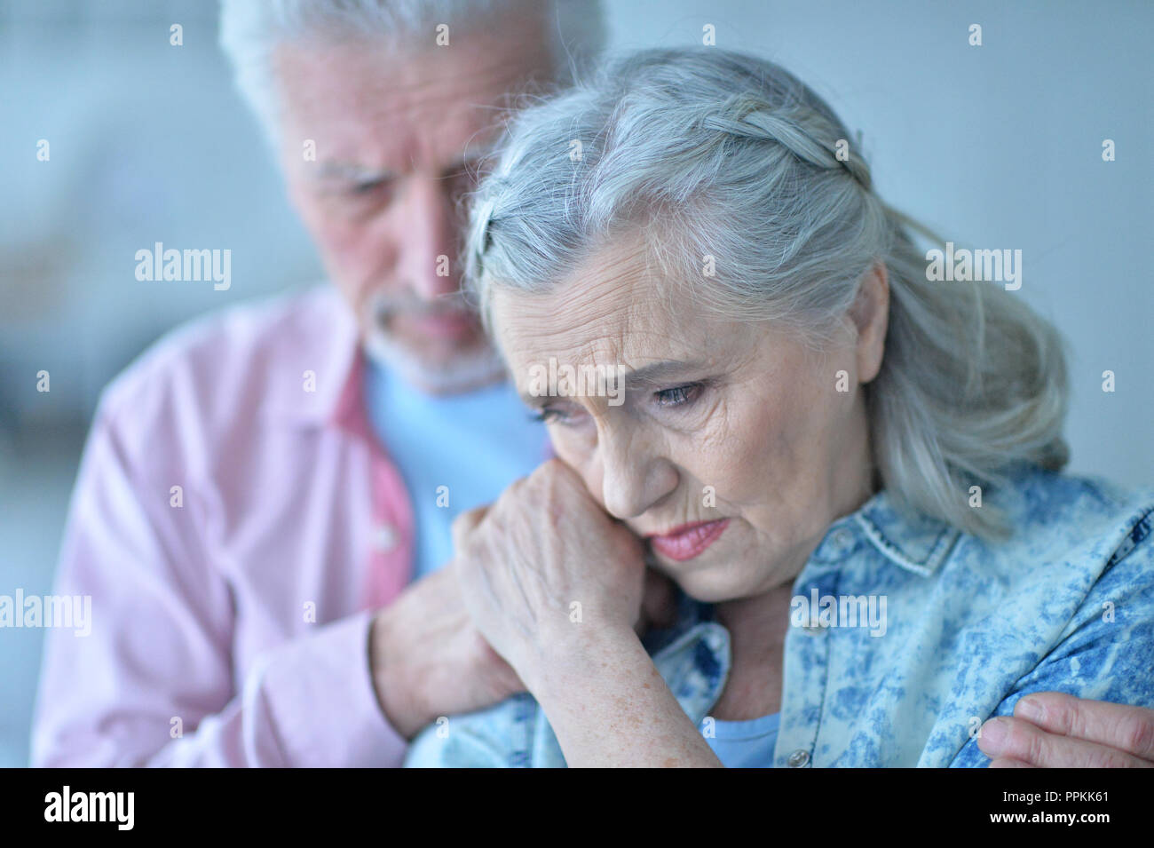 Portrait of sad senior couple at home Stock Photo - Alamy