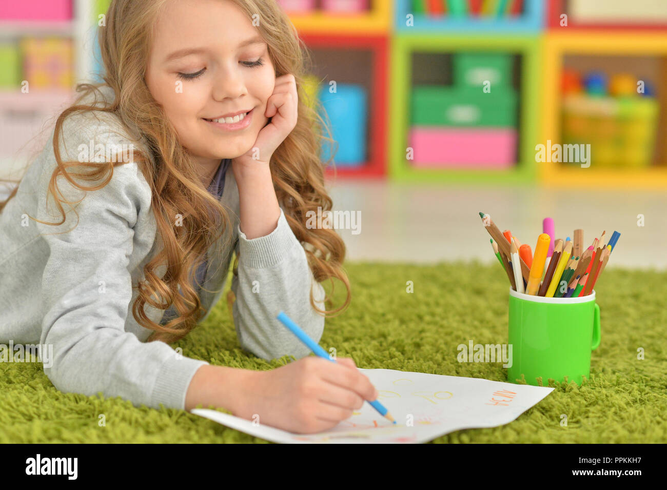 cute girl drawing while lying on floor Stock Photo - Alamy cute girl drawing while lying on floor Stock Photo - Alamy