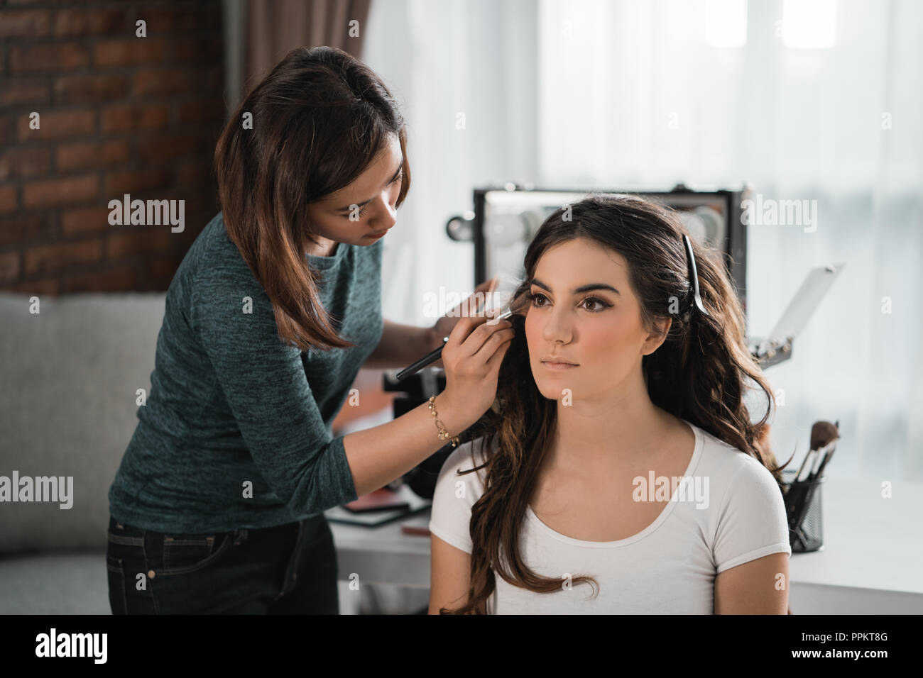 Make-up process for beautiful woman Stock Photo - Alamy