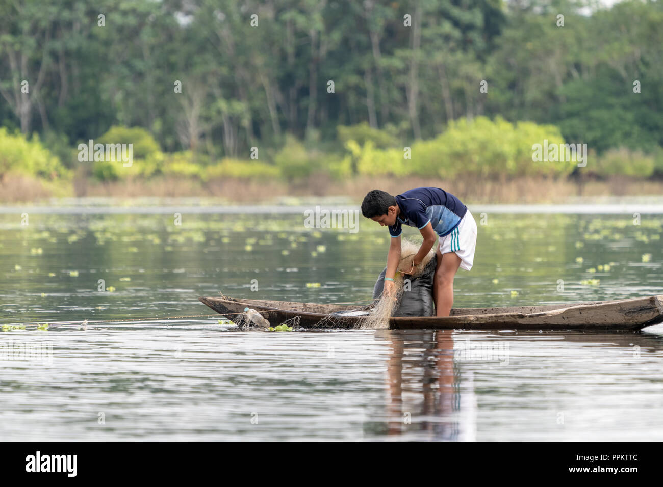 Pacaya Samiria Reserve, Peru, South America. Young boy checking his ...