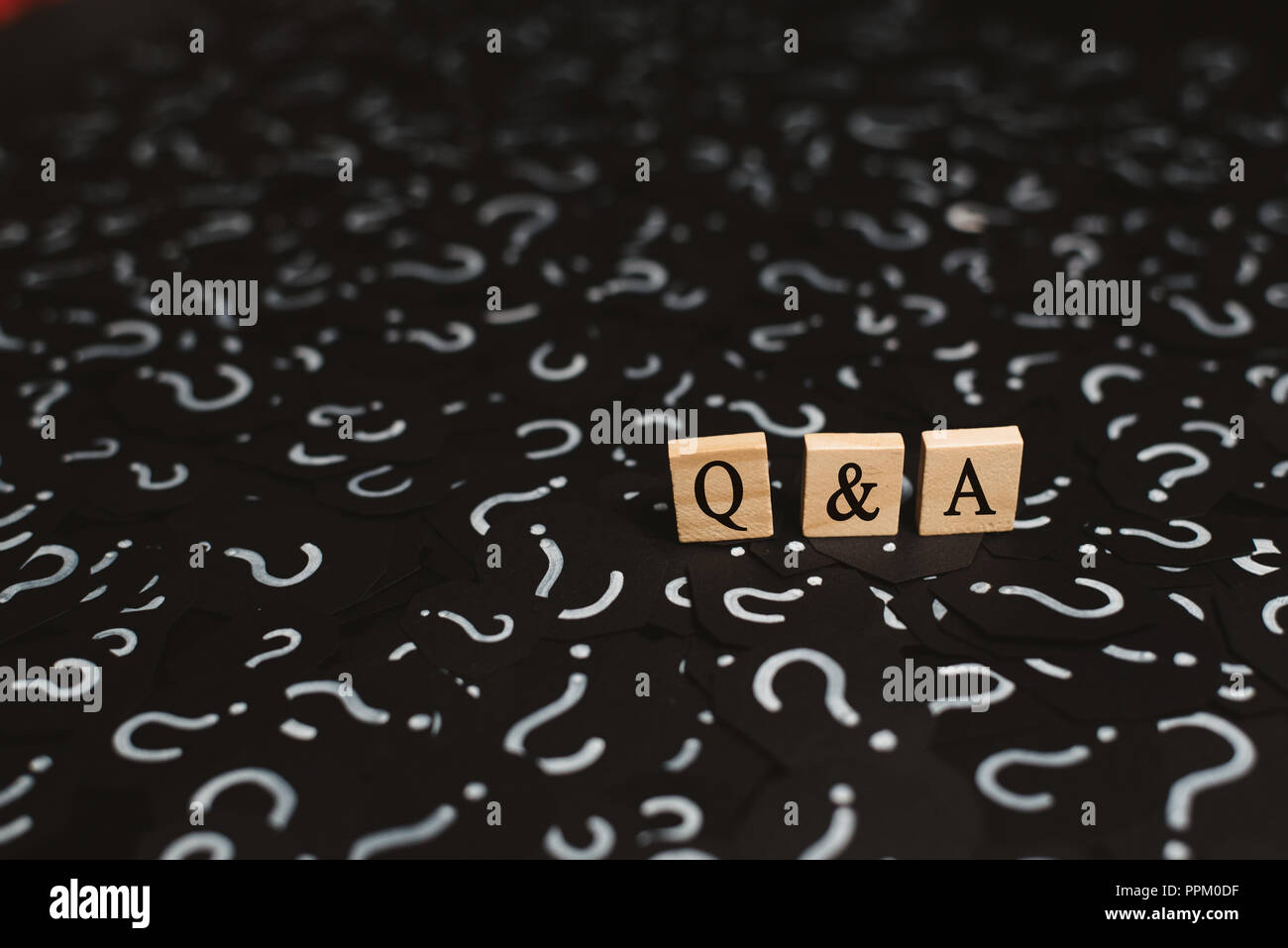 wooden alphabet tiles with Q&A letter on black paper with QUESTION MARK ...