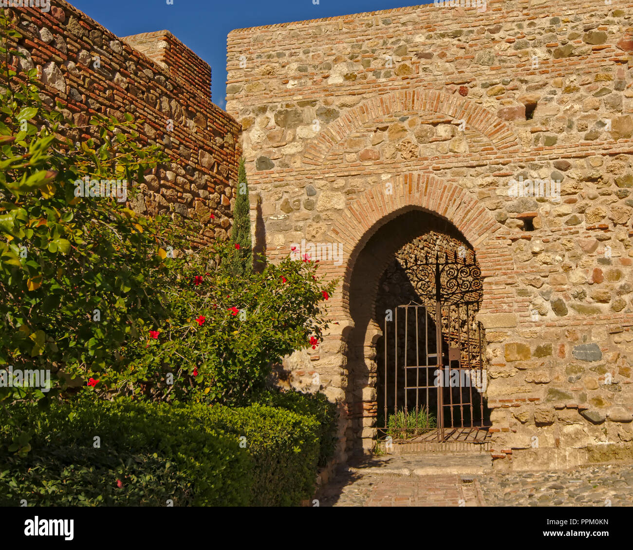 Gate in a fortified wall Alcazaba moorish castle in Malaga Stock Photo ...