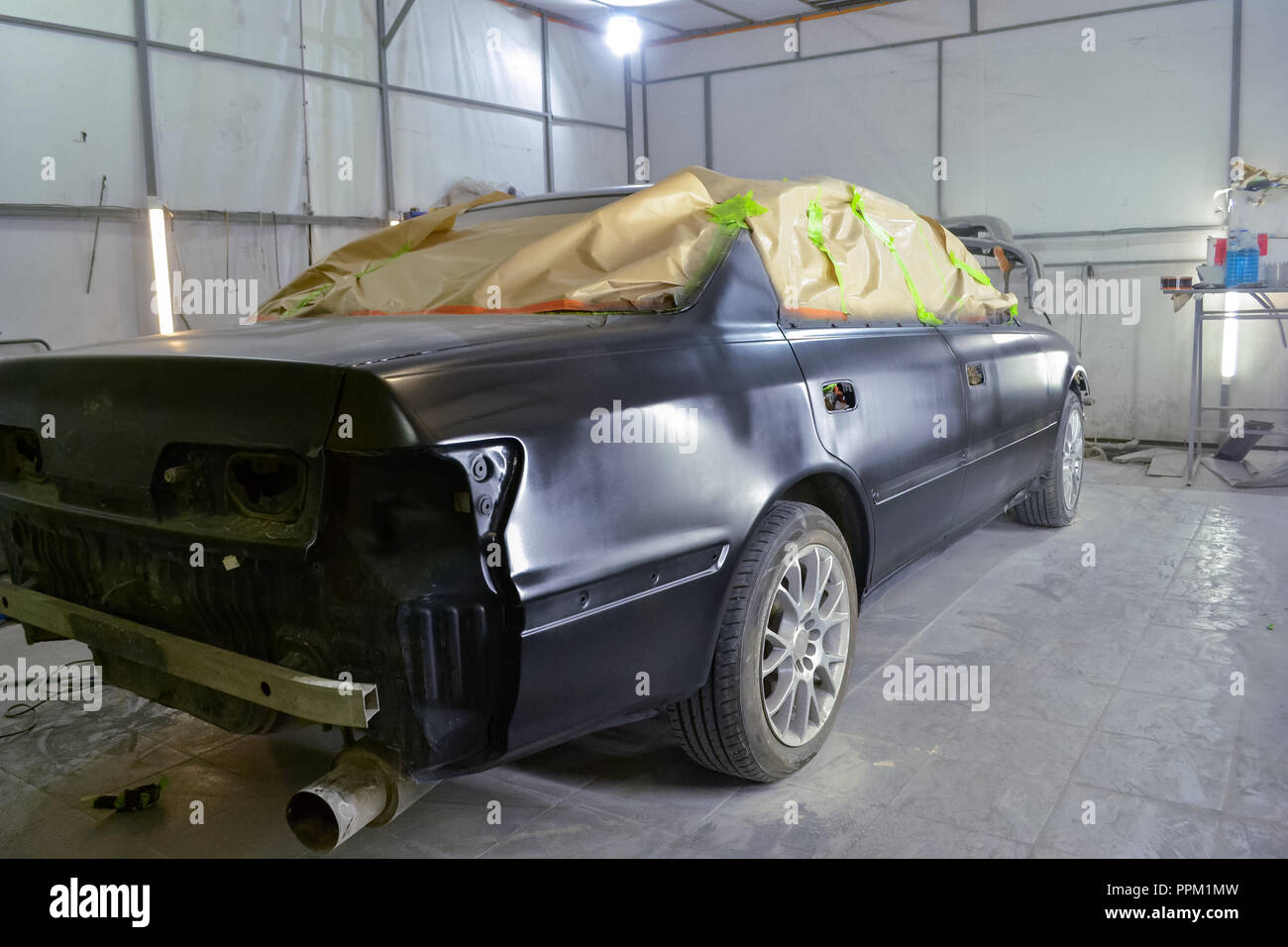 The black car in the body of the sedan after the painting the body with ...