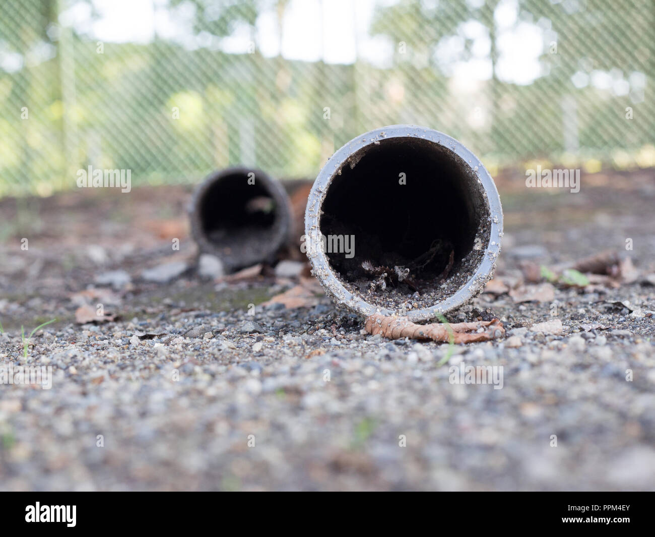 Plastic grey drain pipe filled with some mud Stock Photo - Alamy