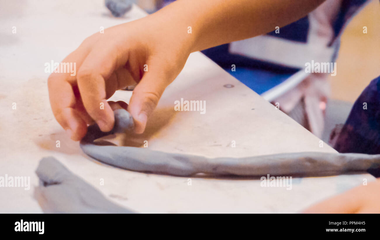Little girls creating small kids sculptures from clay Stock Photo - Alamy