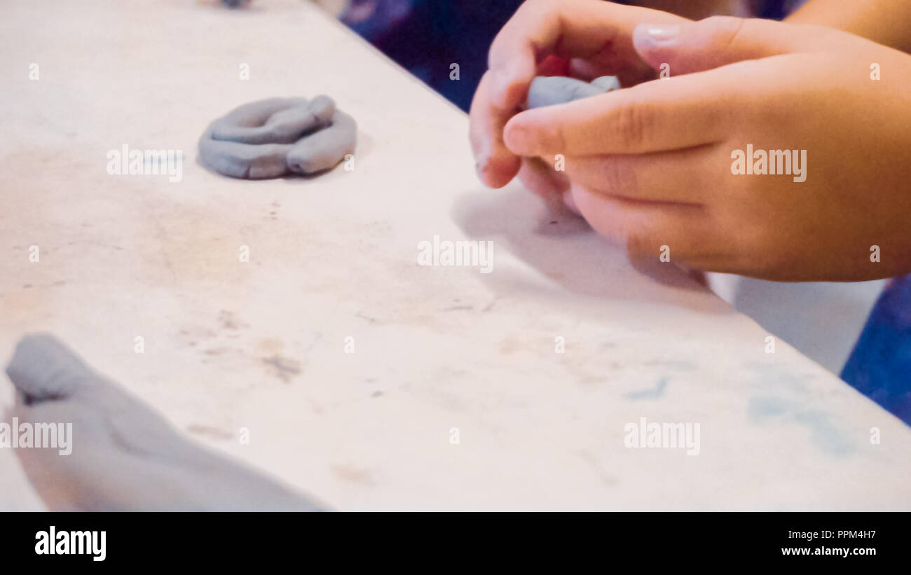 Little girls creating small kids sculptures from clay Stock Photo - Alamy