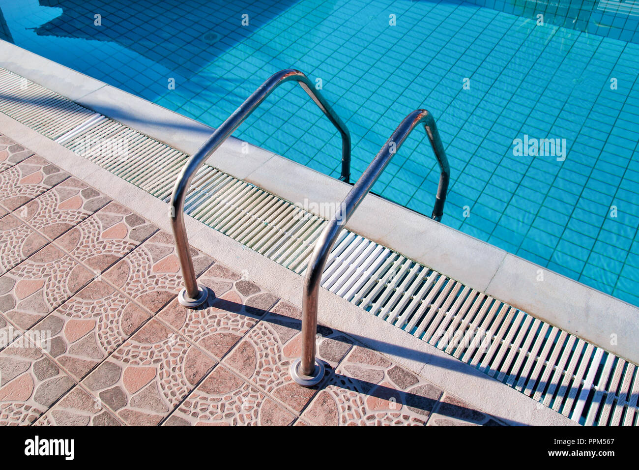 Handrail on the pool. Swimming pool with stair closeup. Pool handrails ...