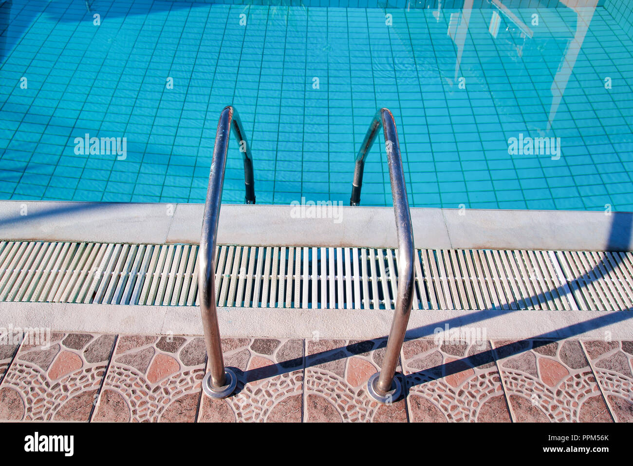 Handrail on the pool. Swimming pool with stair closeup. Pool handrails ...