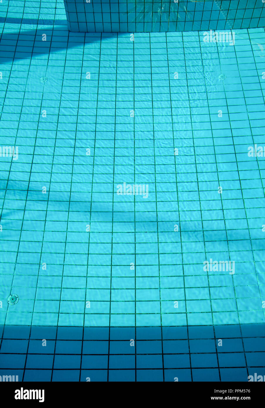 Pattern of sunlight on the bottom of a pool. Poolside pool swimming ...