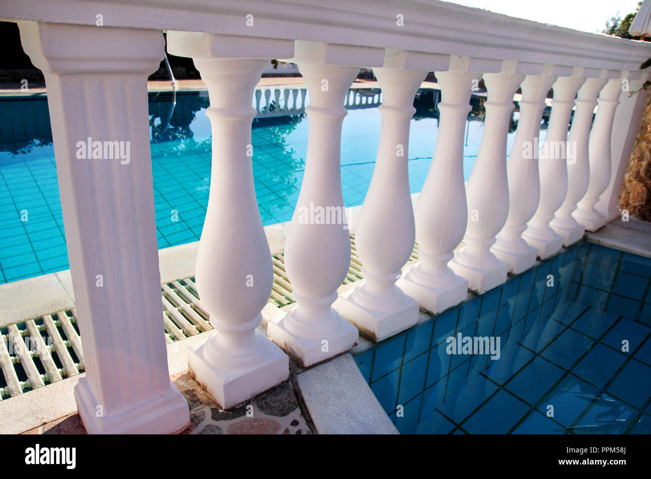 White pillars classic balustrade with empty pool in the background ...