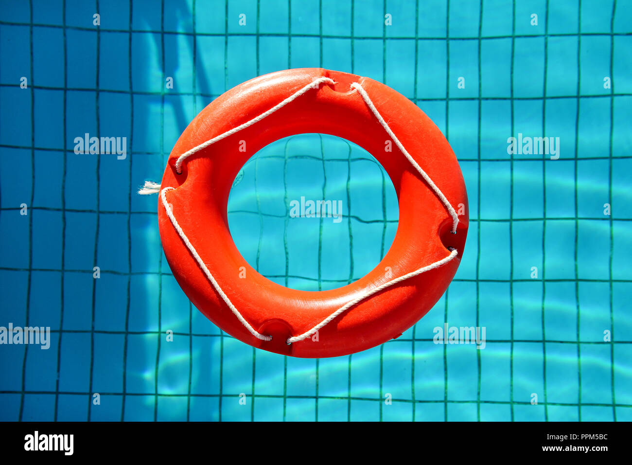 Red lifebuoy pool ring float, ring floating in refreshing blue swimming ...