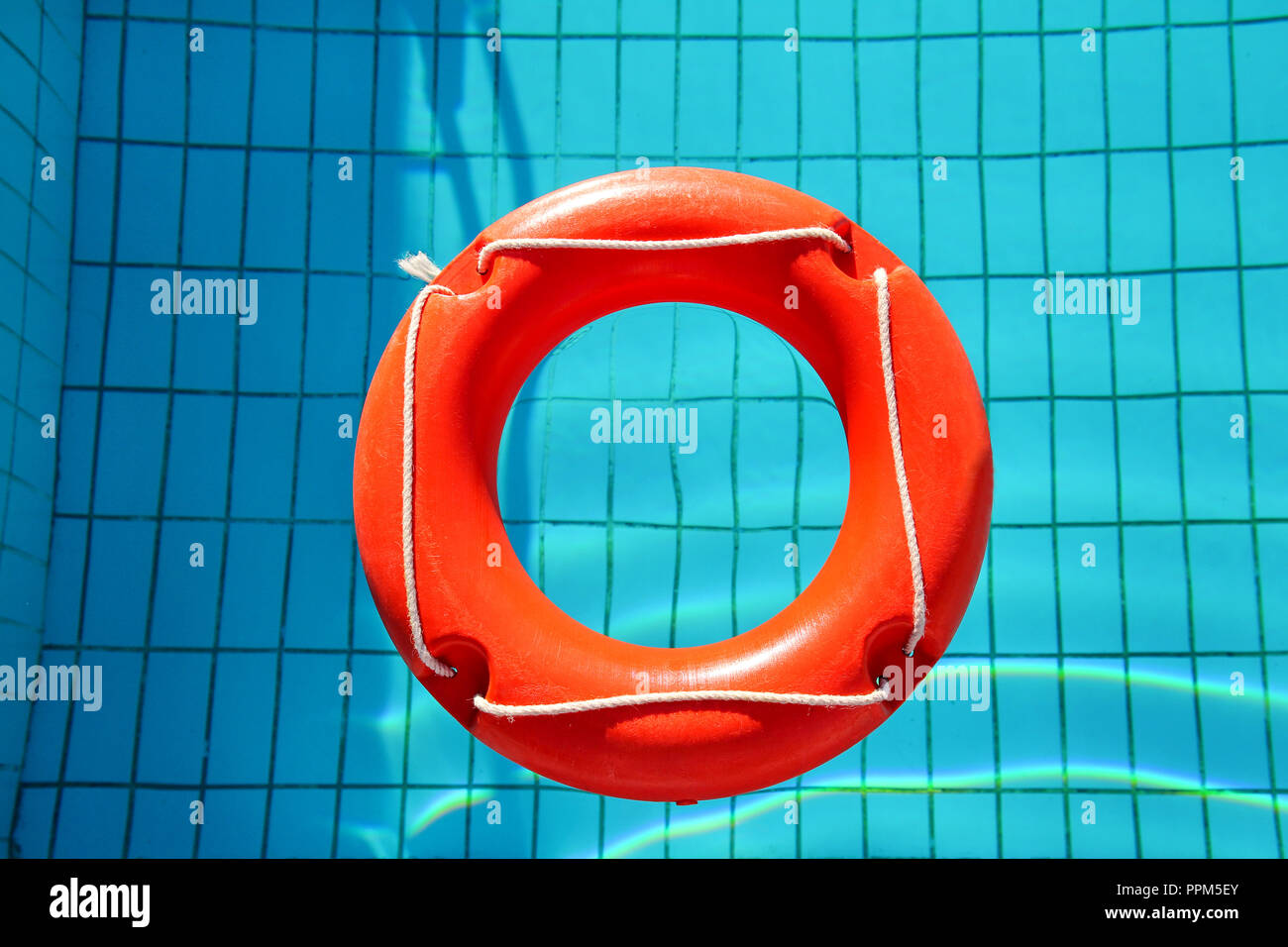 Red lifebuoy pool ring float, ring floating in refreshing blue swimming ...