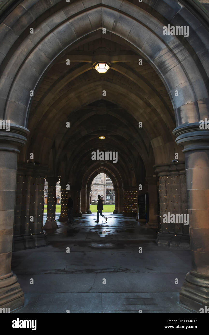 Person walking the Cloisters below Bute Hall of Glasgow University ...