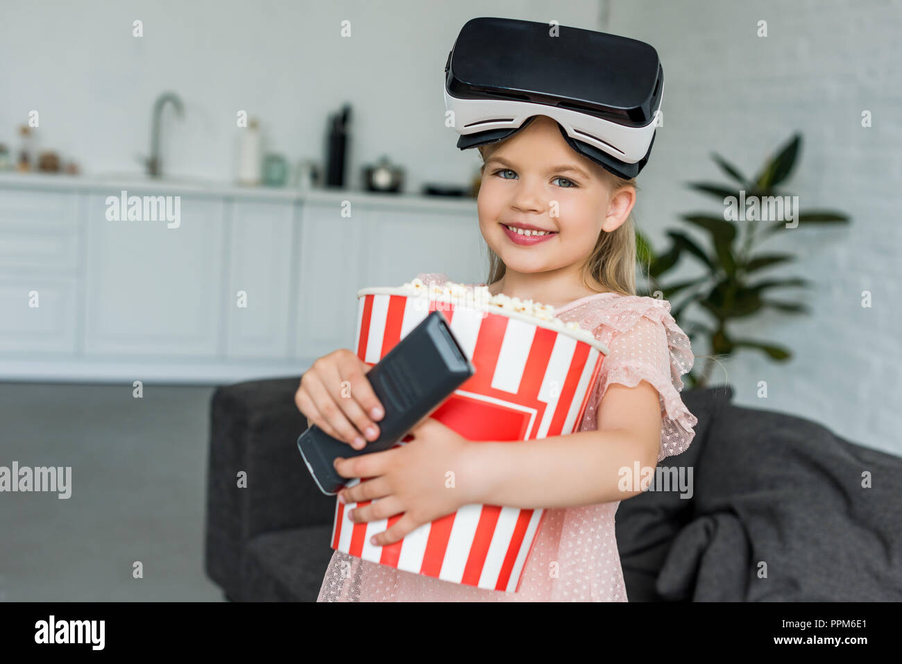adorable smiling child in virtual reality headset holding box with ...