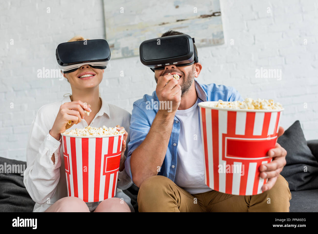 Young couple eating popcorn using hi-res stock photography and images ...