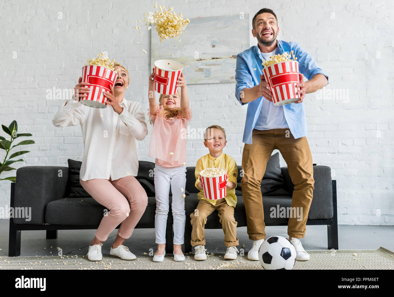 excited family holding boxes and throwing popcorn at home Stock Photo ...