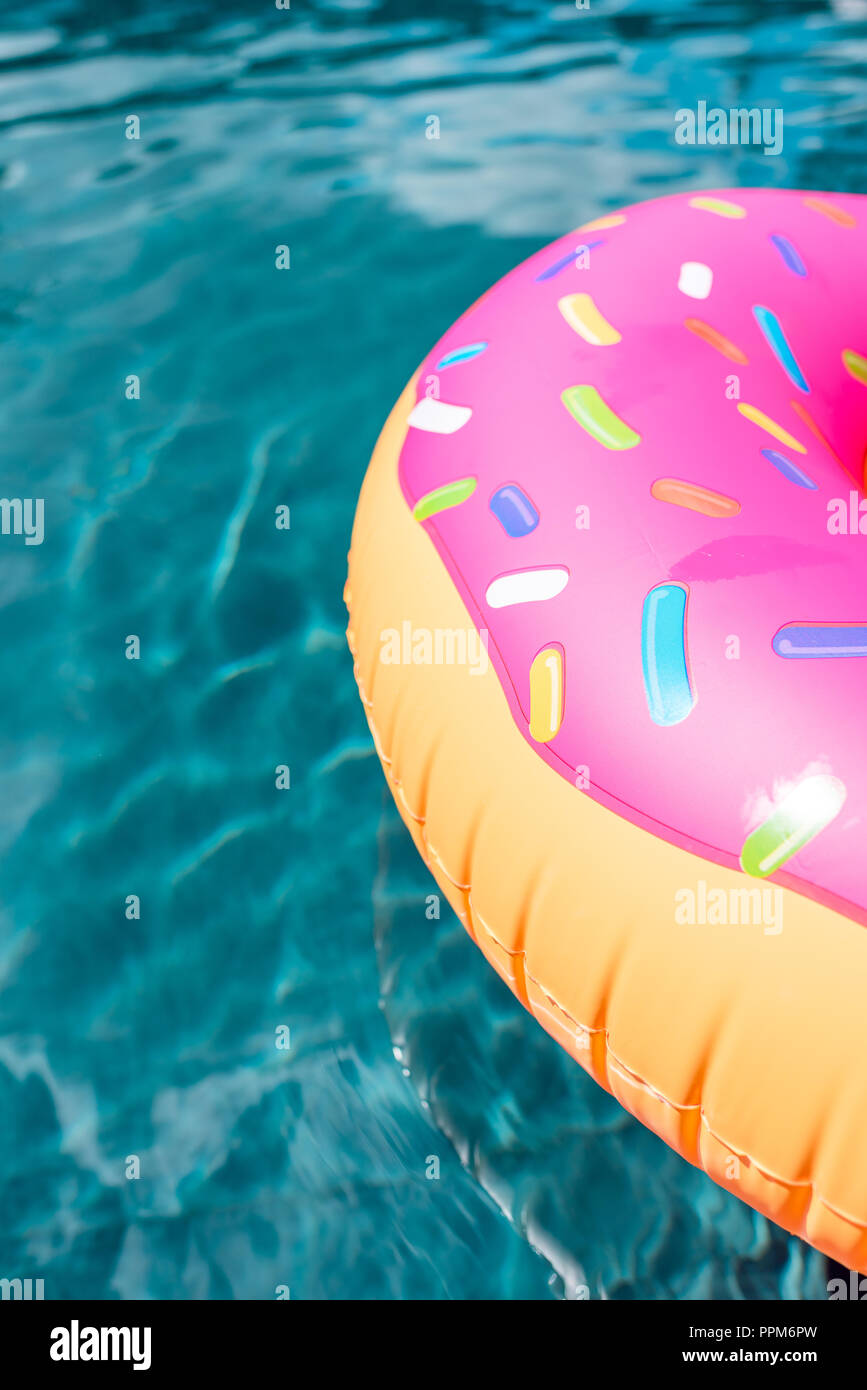 close-up shot of inflatable ring in shape of donut floating in swimming ...