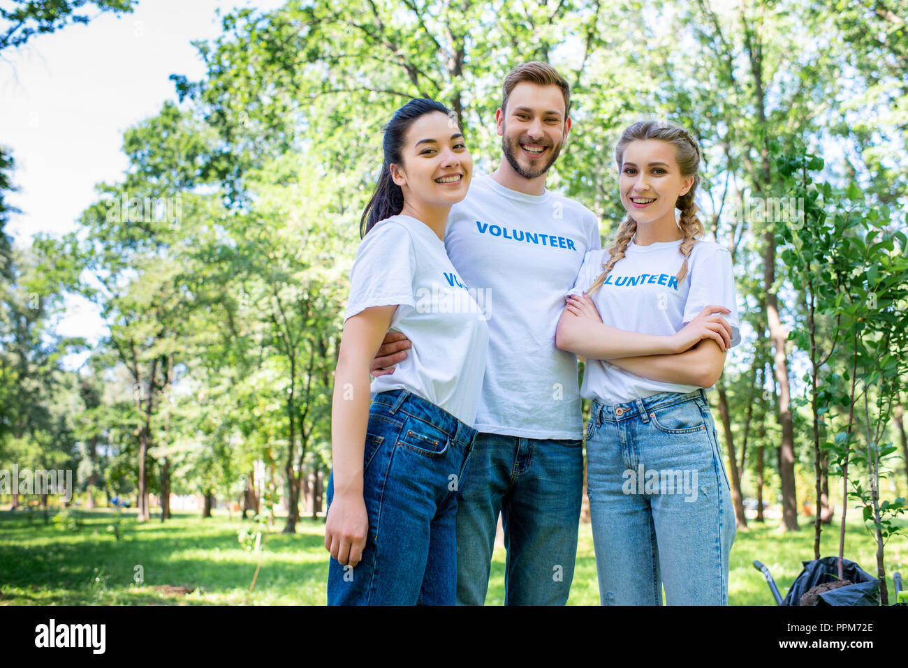 young volunteers hugging in park together Stock Photo - Alamy