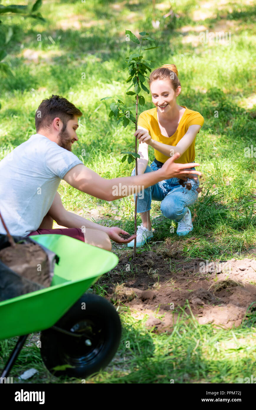 Young couple planting tree together hi-res stock photography and images ...