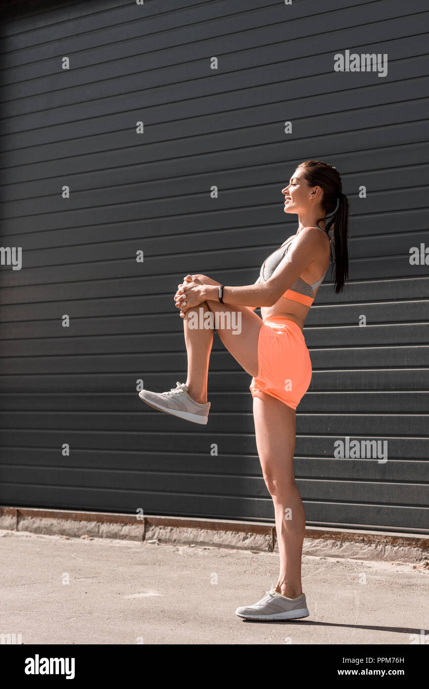 Athletic woman stretching legs hi-res stock photography and images - Alamy