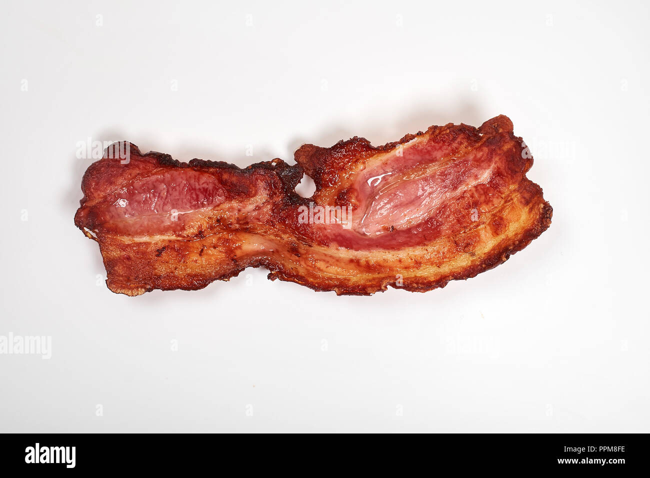 crispy fried bacon isolated on a white background Stock Photo - Alamy