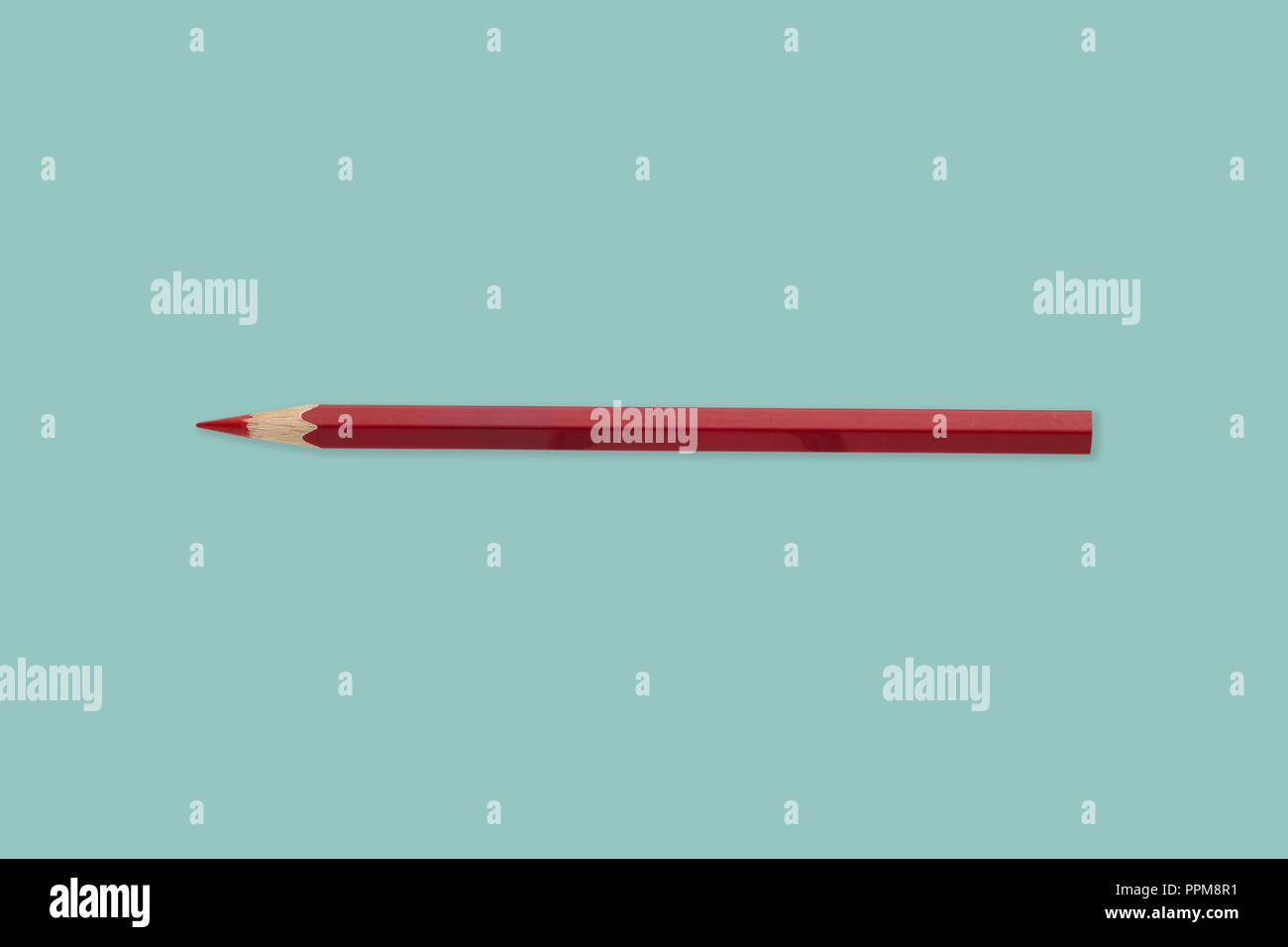 red color pencil on green background Stock Photo - Alamy