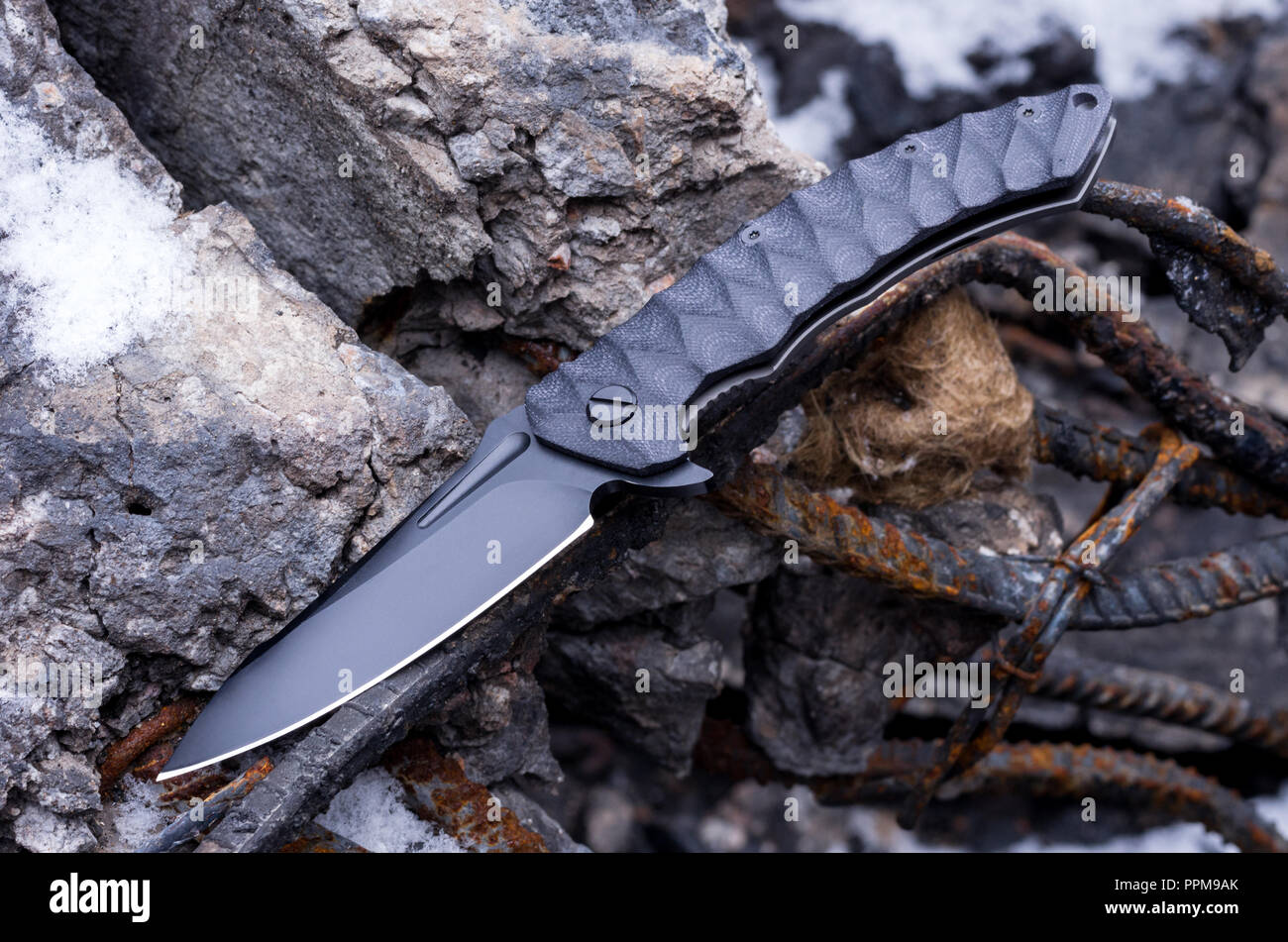 The knife is located diagonally across the frame. The frame is divided ...