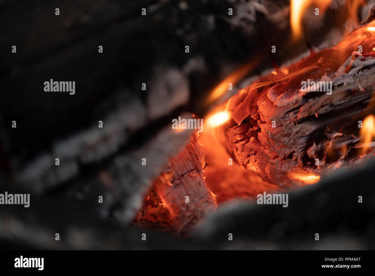 Burning wood in flames with smoke Stock Photo - Alamy