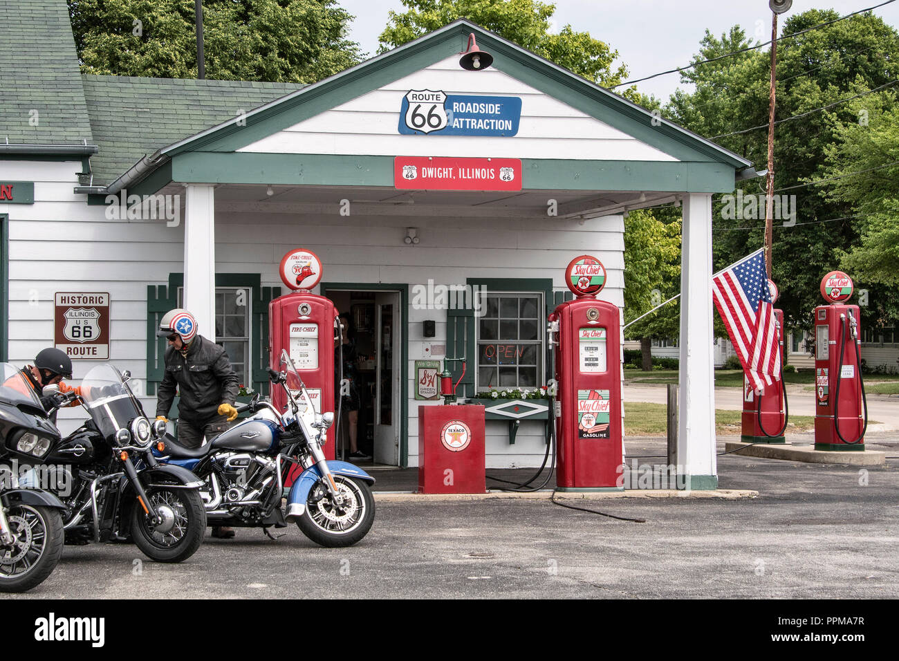 Harley Davidson motorcycles parked in front of historic gas station ...