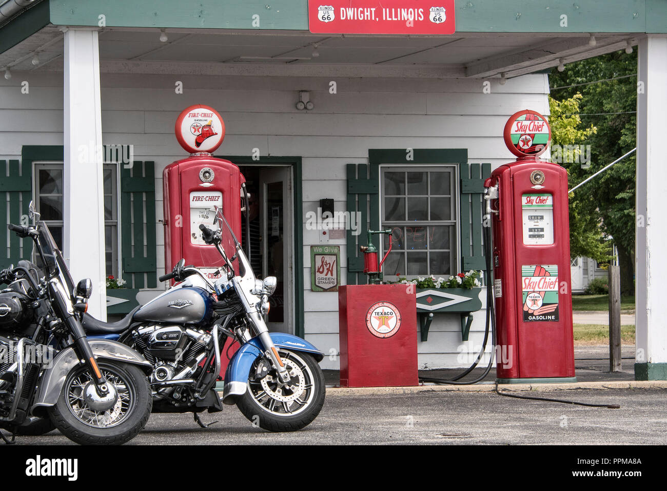 Harley Davidson motorcycles parked in front of historic gas station ...