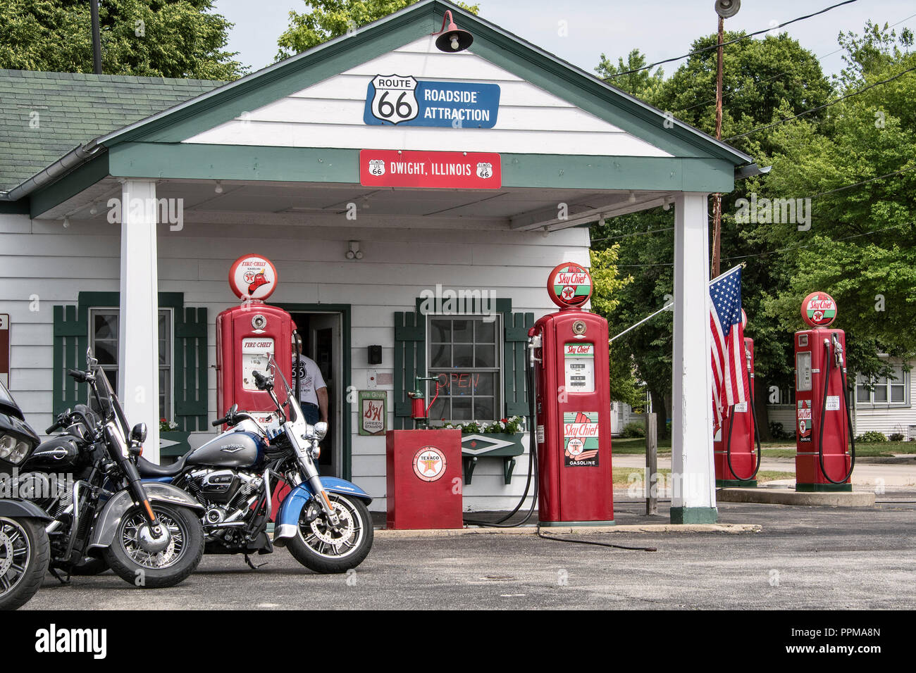 Harley Davidson motorcycles parked in front of historic gas station ...