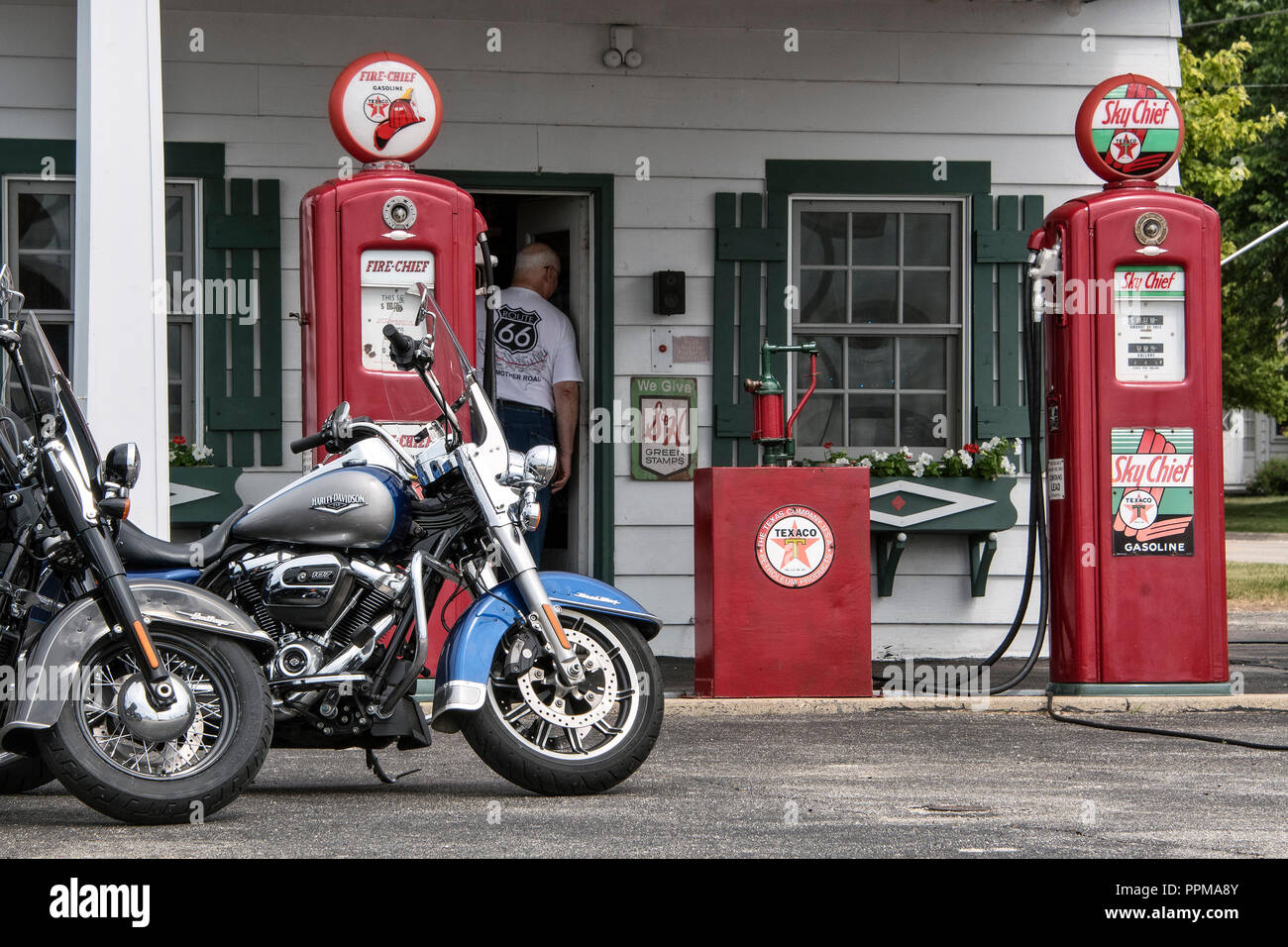 Harley Davidson motorcycles parked in front of historic gas station ...