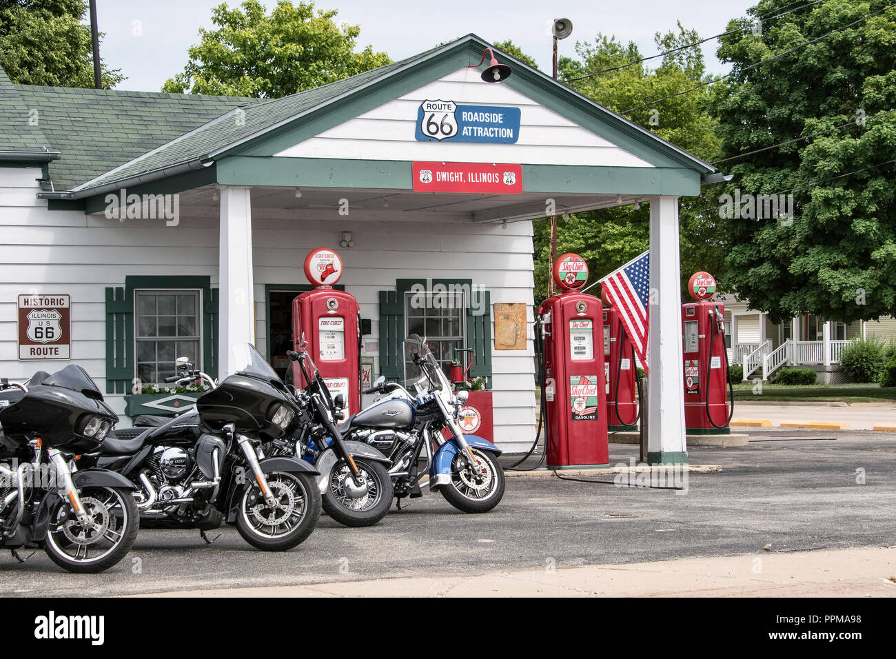 Harley Davidson motorcycles parked in front of historic gas station ...