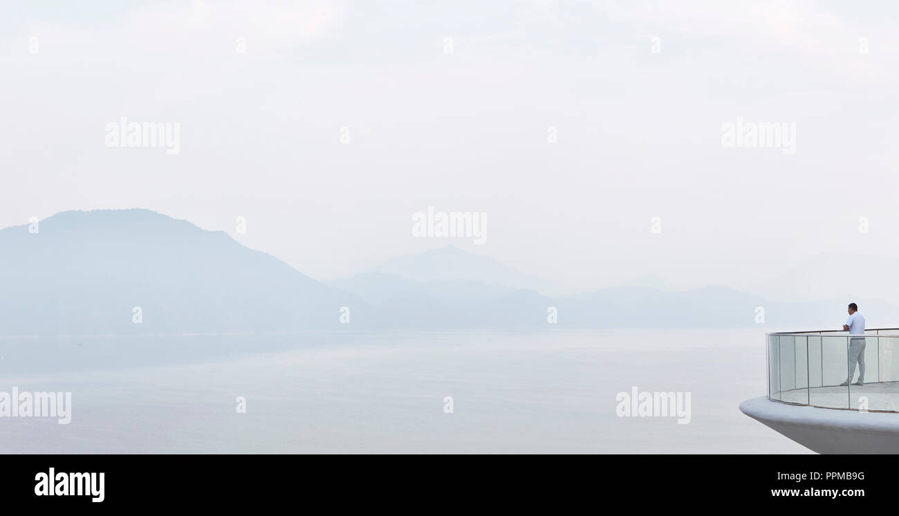 Balcony detail with figure looking out over Taiping Lake. Huangshan ...