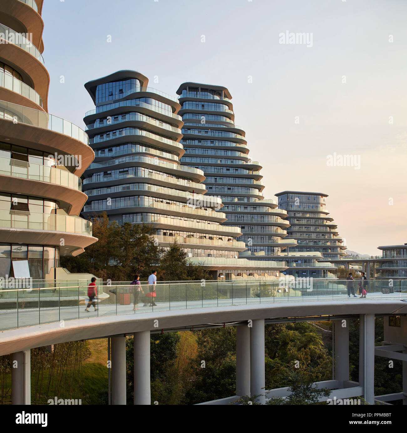 Perspective along vertical housing clusters with pedestrian bridge ...