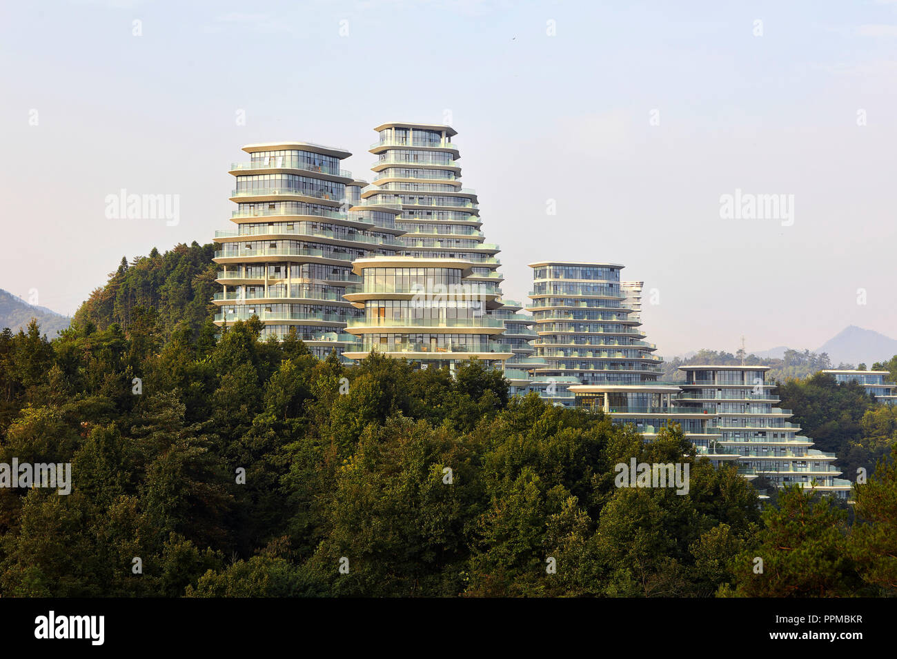 Exterior facade of housing cluster on hill. Huangshan Village ...
