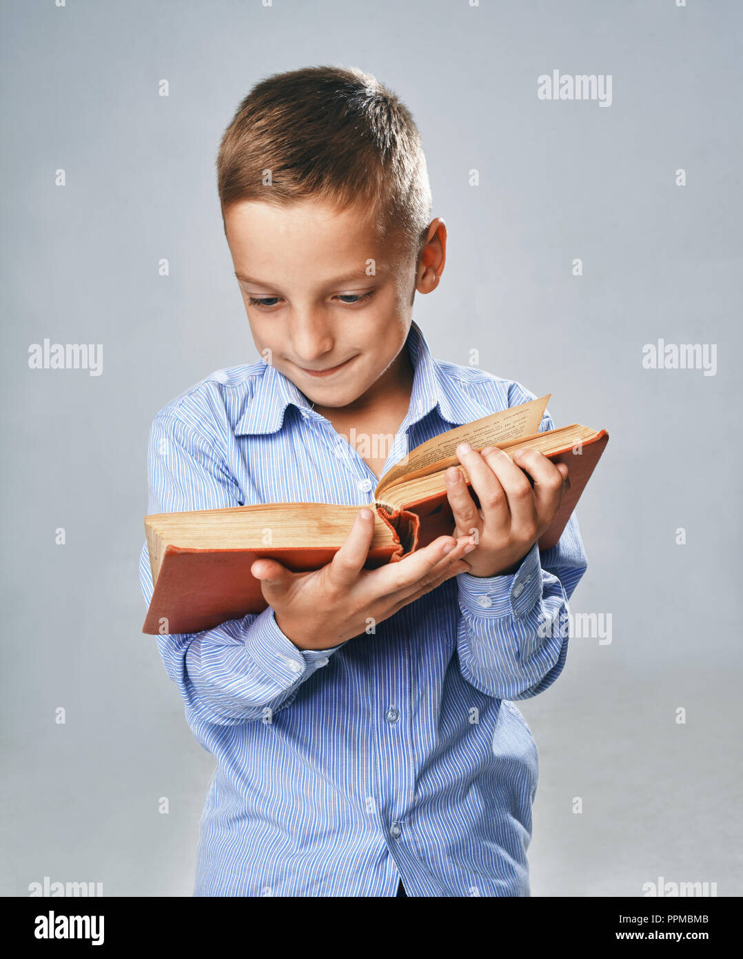 portrait of a boy with a big book Stock Photo - Alamy