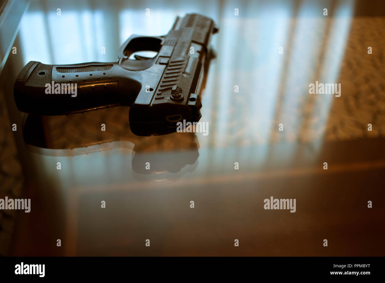Automatic pistol gun on glass table in bedroom in luxury hotel in ...