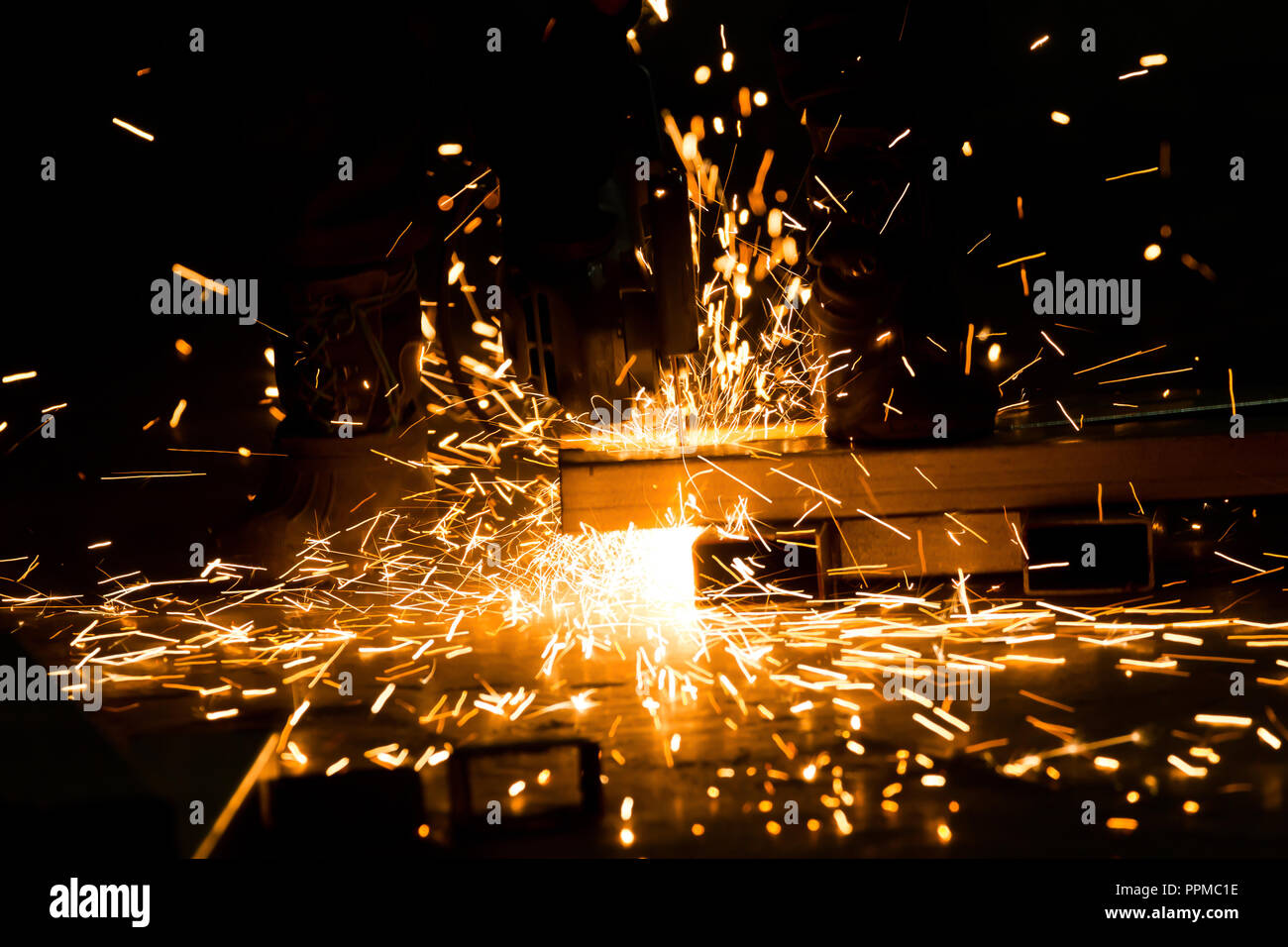 sharpening and cutting of iron by abrasive disk machine Stock Photo - Alamy