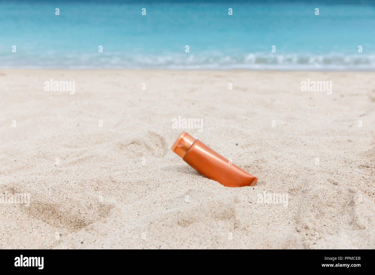 Sunscreen sunblock spf cream on the sea beach sand summer tropical ...