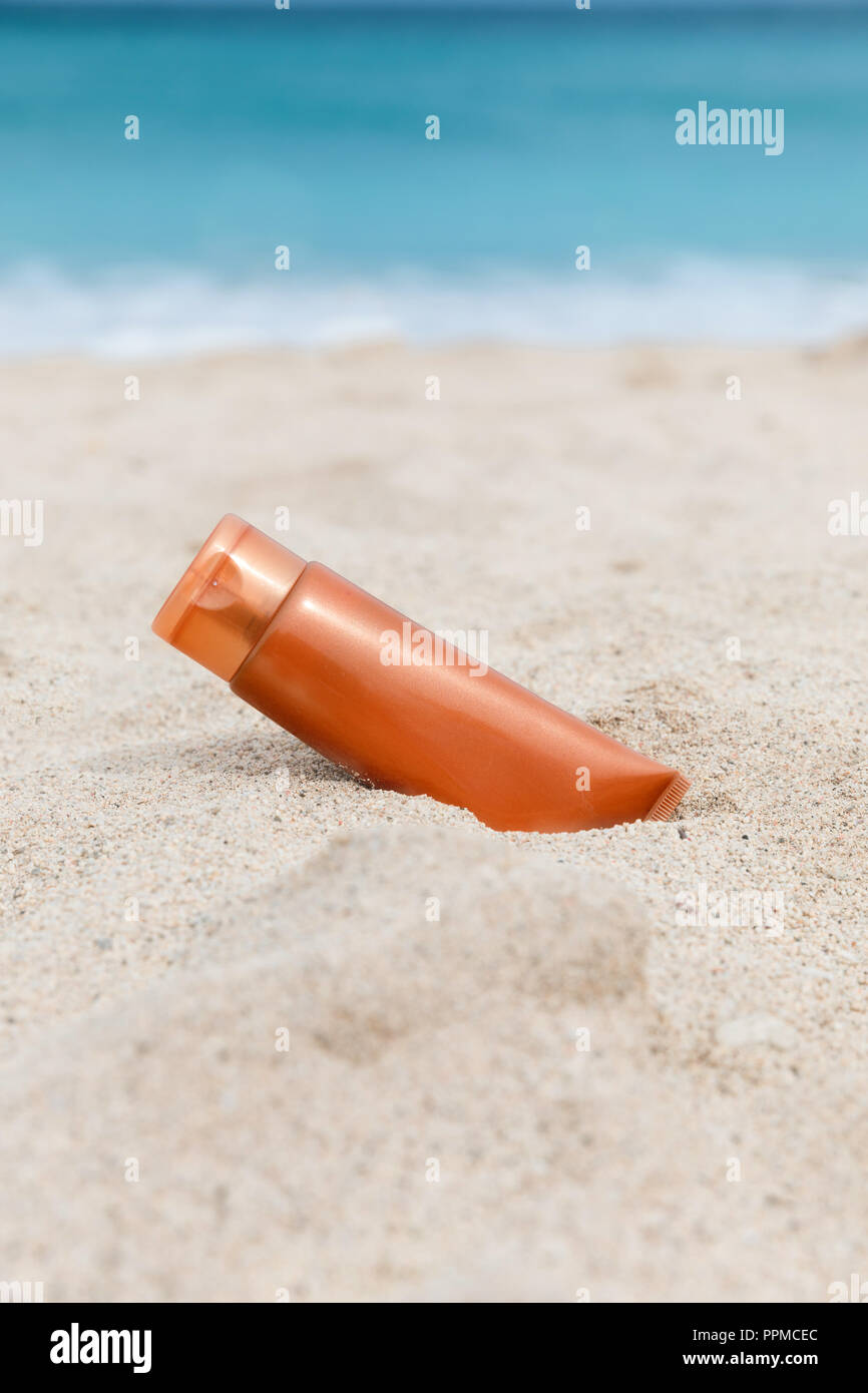 Sunscreen sunblock spf cream on the sea beach sand summer tropical ...