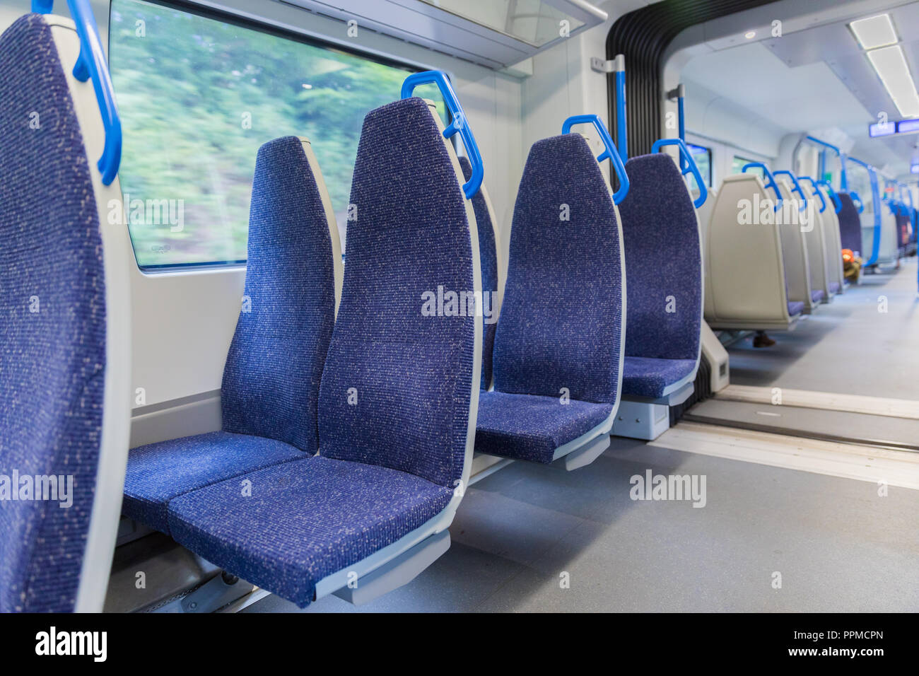 Electric train blue sits interior express europe Stock Photo - Alamy