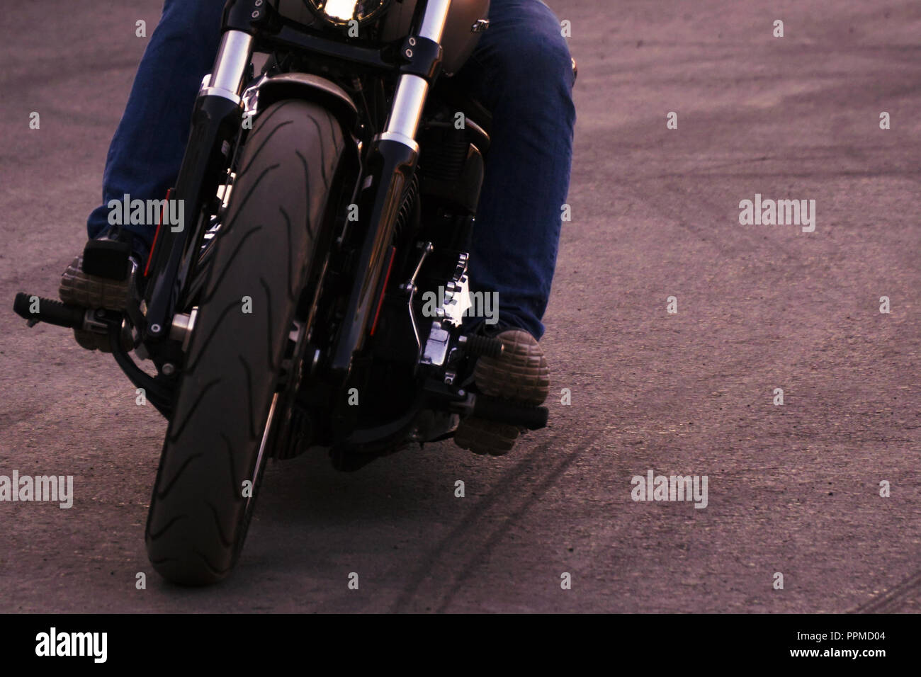 Biker iriding a motorcycle. Front view Stock Photo - Alamy