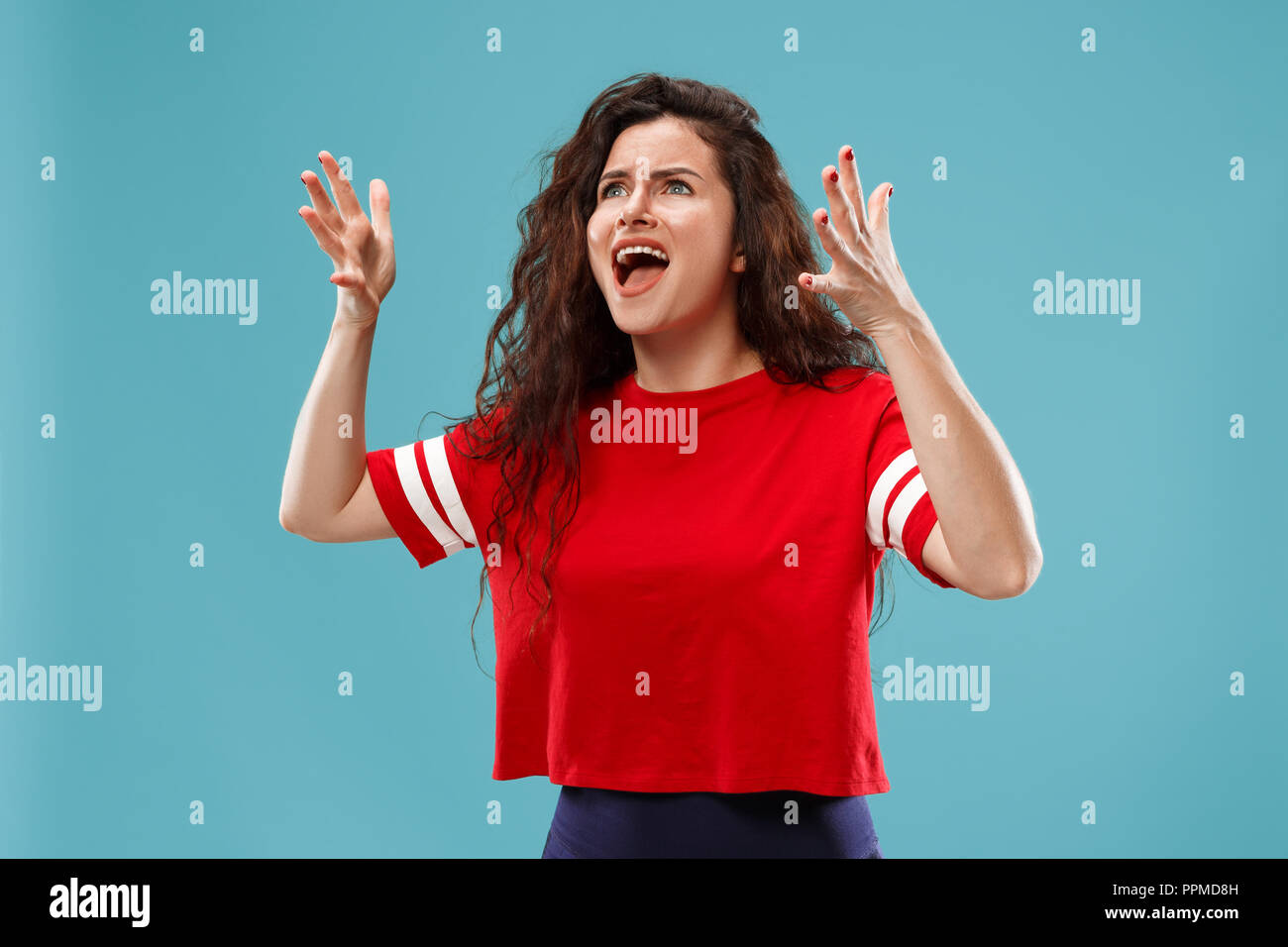 Screaming, hate, rage. Crying emotional angry woman screaming on blue ...