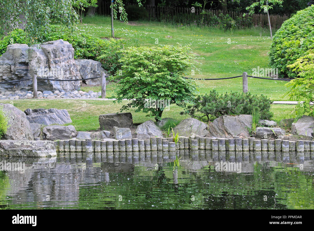 Man made lake in Japanese zen garden Stock Photo - Alamy