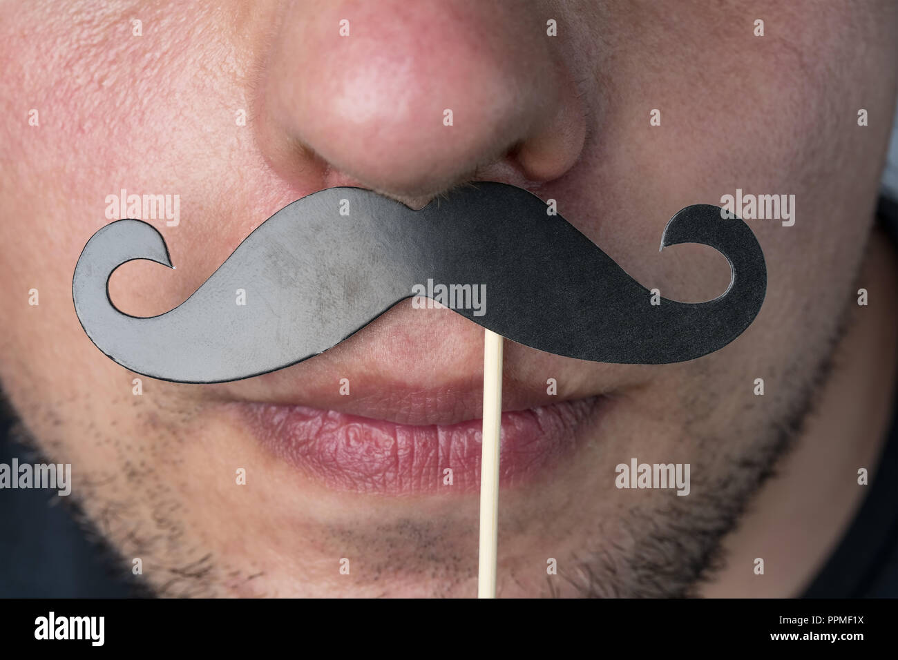 Man with photo booth prop moustache for november cancer awareness month ...