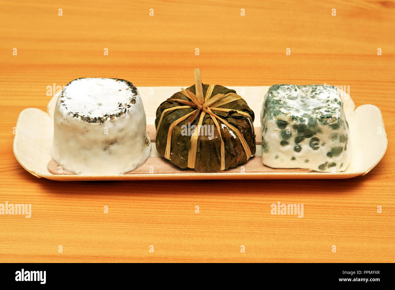 Fine goat cheese selection at wooden tray Stock Photo - Alamy